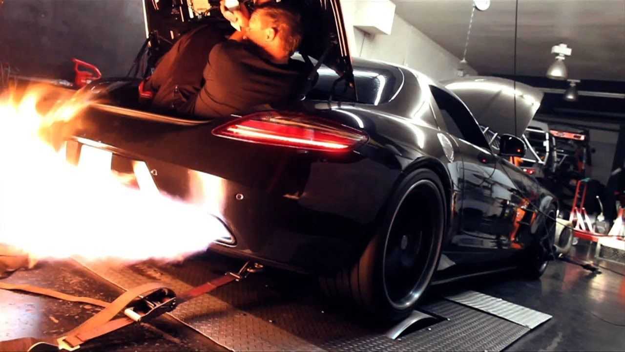 SLS AMG spewing flames and a guy is in the trunk. Nothing is faked.
